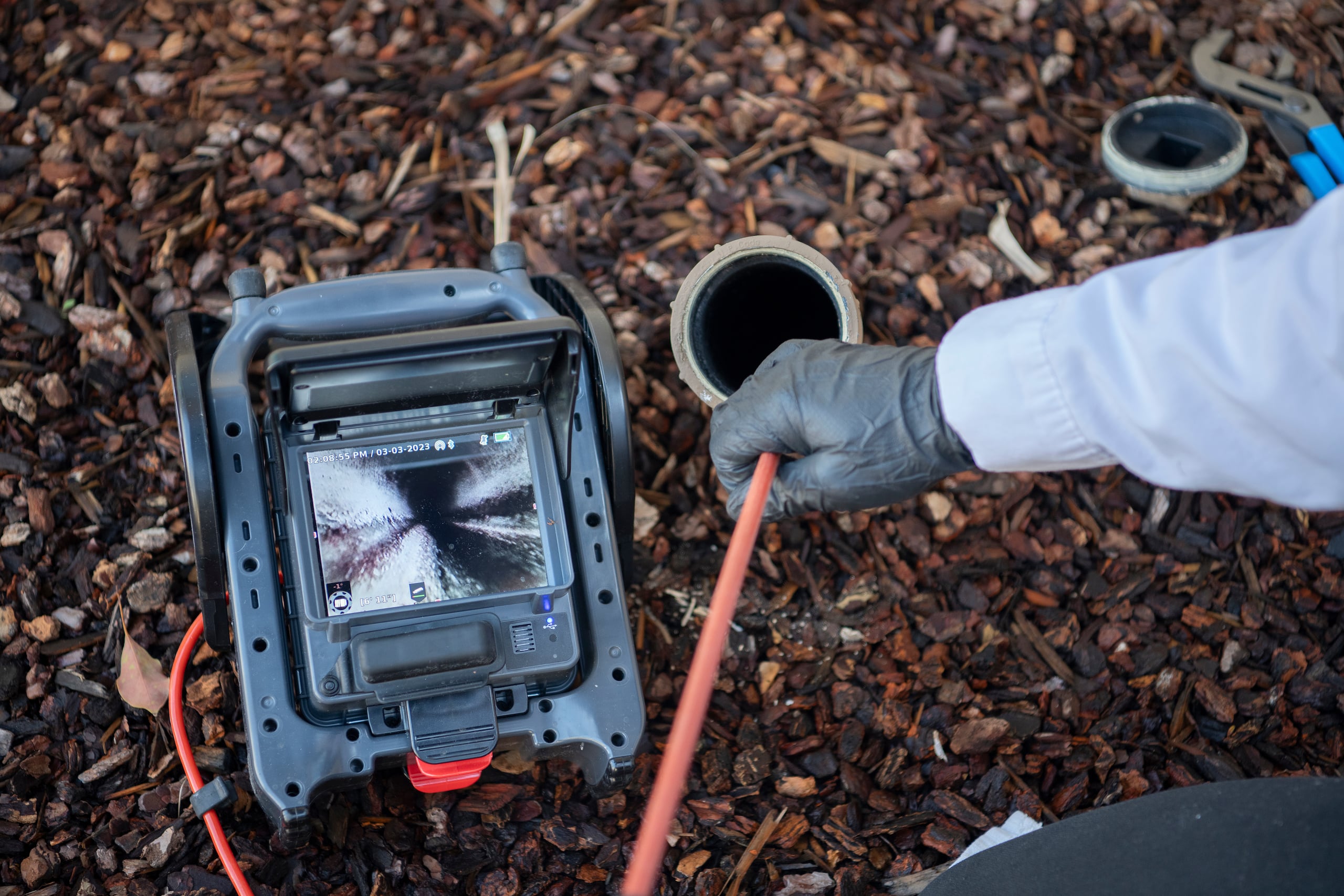 Technician runs inspection camera sewer scope down drain - Poole's ...